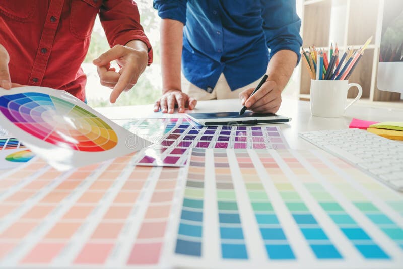 Two Graphic Designer Drawing on Graphics Tablet and Color Palette Guide ...