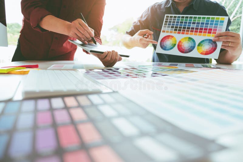 Two Graphic Designer Drawing on Graphics Tablet and Color Palette Guide ...