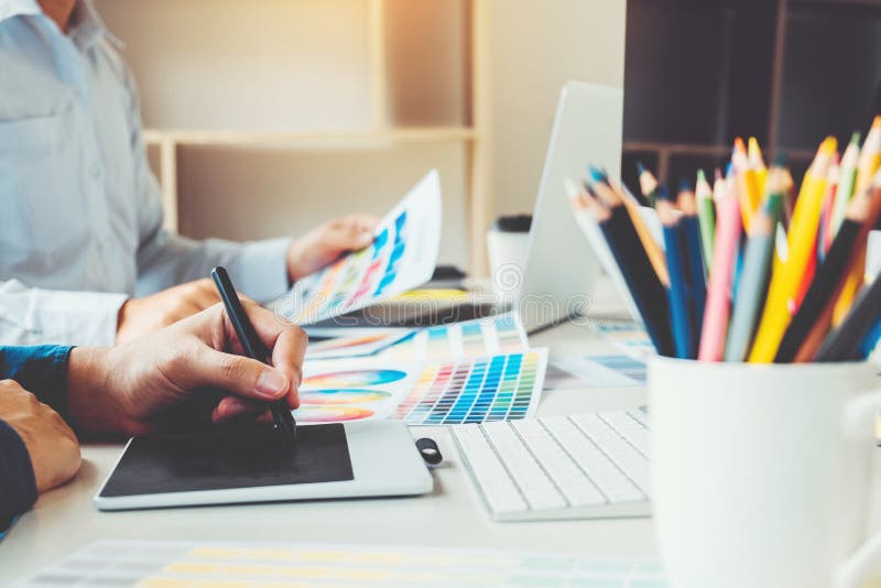 Two Graphic Designer Drawing on Graphics Tablet and Color Palette Guide ...