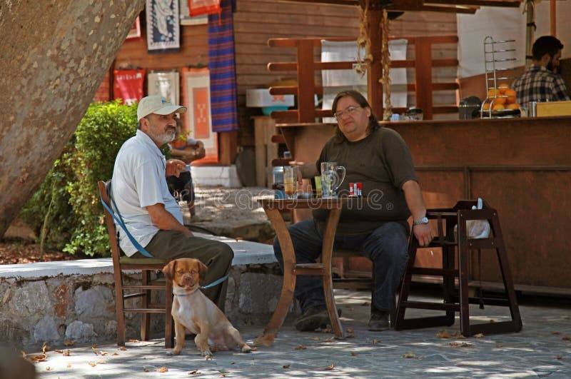 Two Greek Men Sit at a Rustic Outdoor Cafe(Crete,Greece) Editorial ...