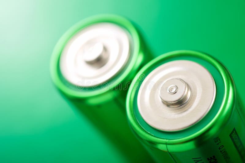 Two Green Batteries on a Green Table Stock Photo - Image of current ...