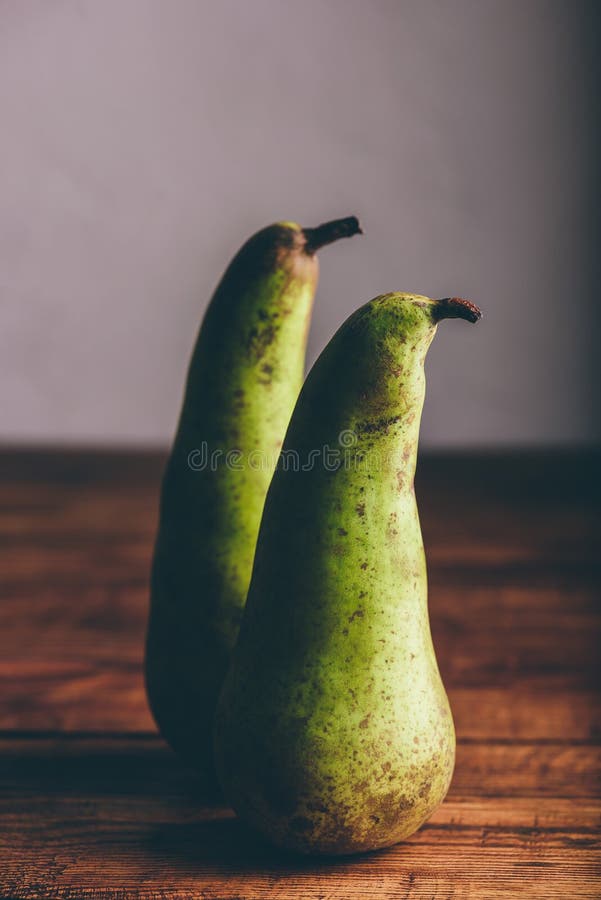 Two Green Pears on Wooden Table Stock Image - Image of group, drink ...