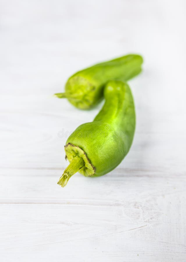 Two Green Pepperoni on White Wooden Stock Photo - Image of color ...