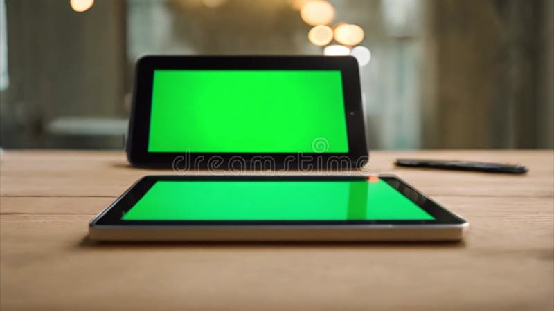 Two Green Screen Tablets on a Wooden Desk Stock Footage - Video of ...