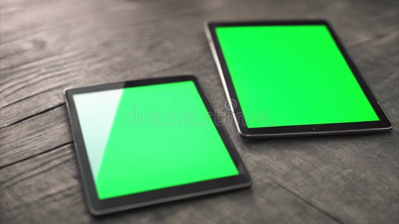 Two Green Screen Tablets on a Wooden Surface Stock Video - Video of ...