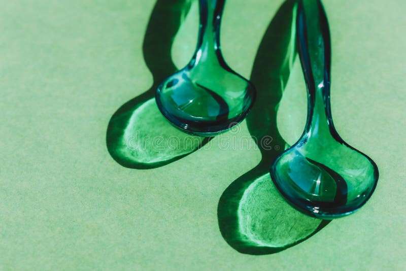 Two Green Transparent Plastic Spoons with Contrasting Shadows Stock ...