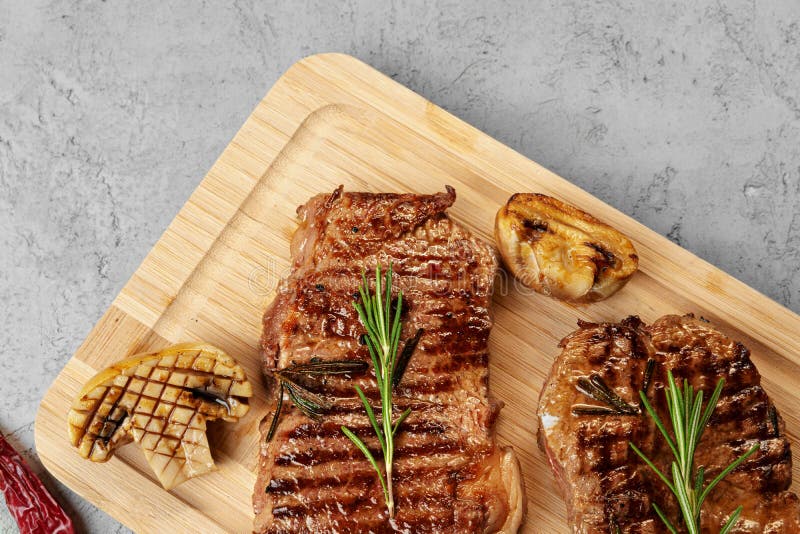 Two Grilled Beef Steaks on Wooden Board Stock Image - Image of meat ...