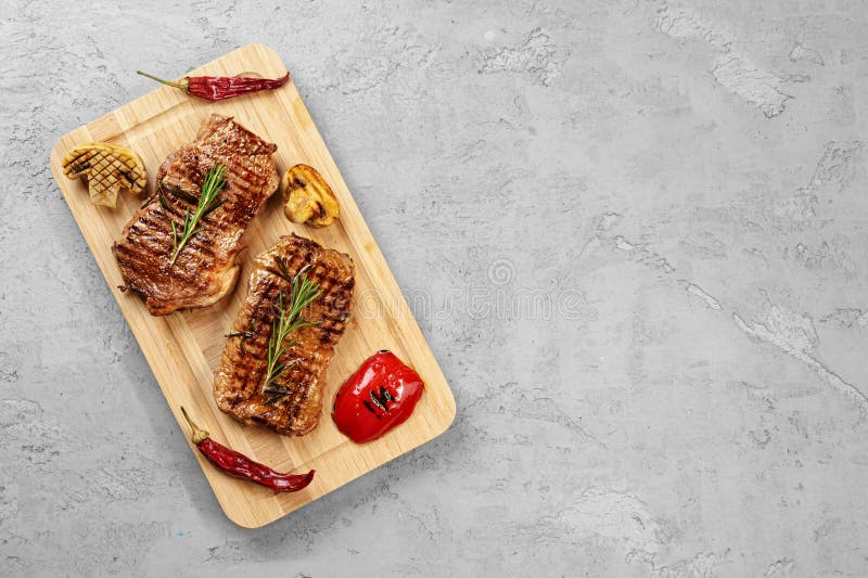 Two Grilled Beef Steaks on Wooden Board Stock Image - Image of steak ...