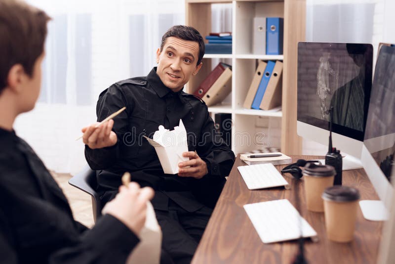 Two Guards Have Lunch in the Workplace. Stock Photo - Image of guard ...