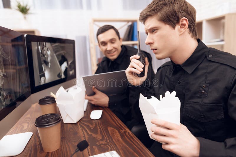 Two Guards Have Lunch in the Workplace. Stock Photo - Image of protect ...