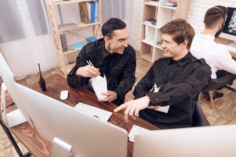 Two Guards Have Lunch in the Workplace. Stock Image - Image of officer ...