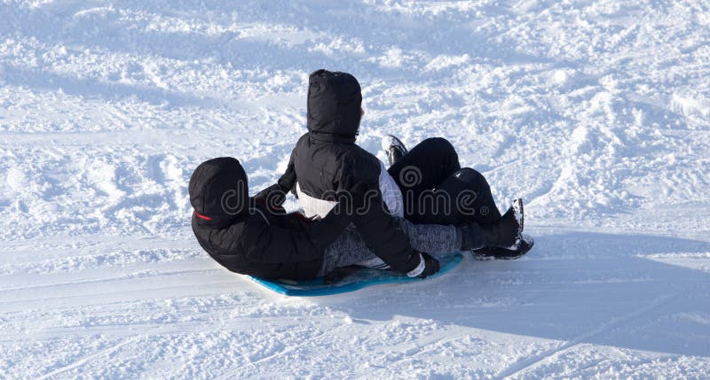 Two Guy Riding the Hills on Sleds Stock Photo - Image of winter, snow ...