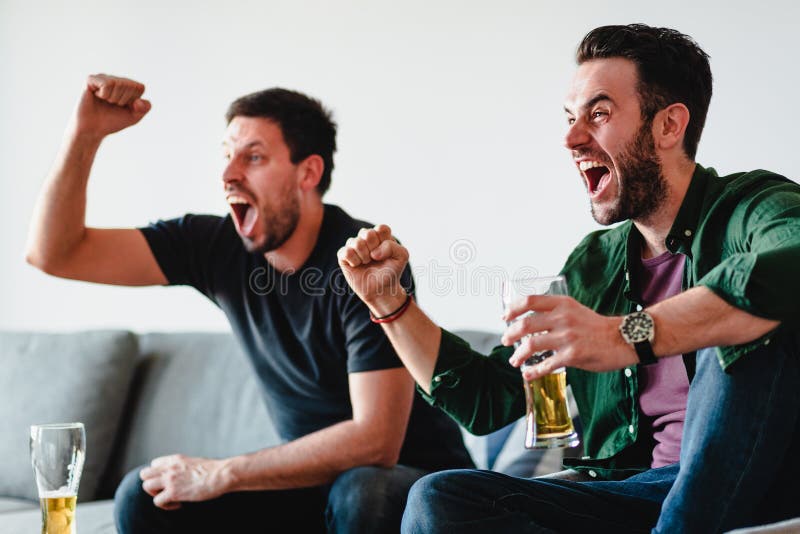 Two Guys Drinking Beer Watching Football Stock Image - Image of ...