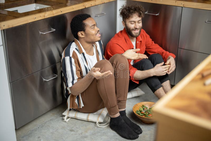 Two Guys Having Close Conversation while Sitting at Kitchen Stock Image ...
