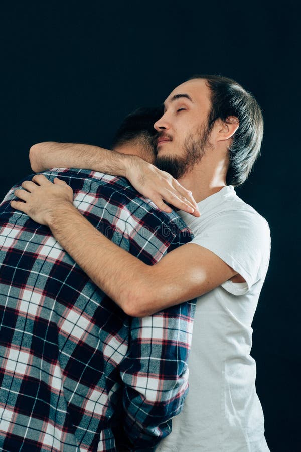 Two Guys Hugging on a Dark Background Stock Image - Image of college ...