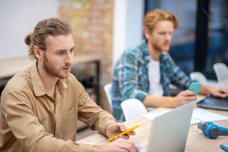 Two Guys Looking Serious while Working on the Laptops Stock Image ...