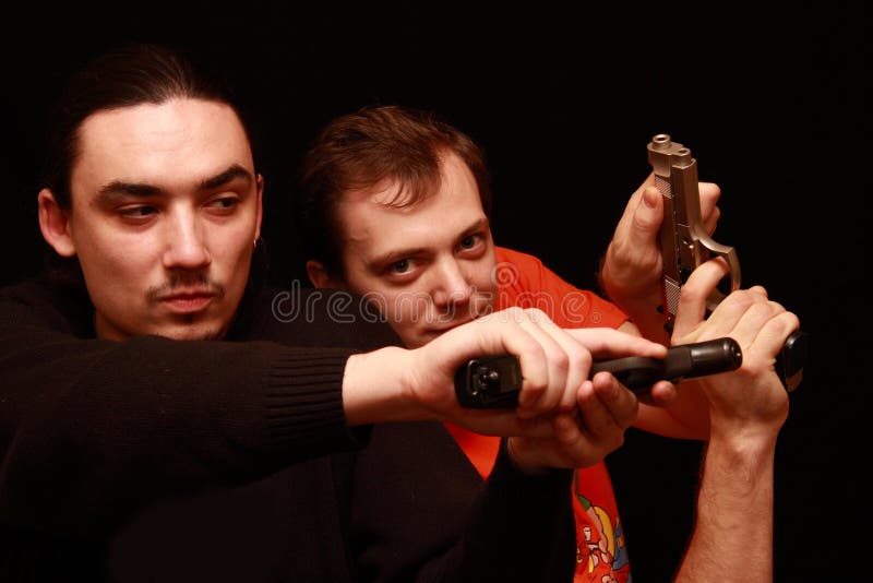 Two guys playing with gun stock photo. Image of bang, smith - 7296444