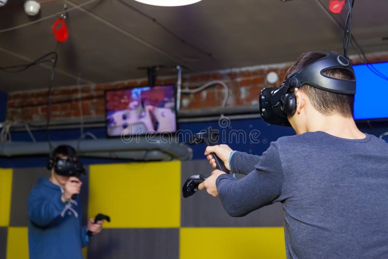 Two Guys Plays a Fight Connected To Virtual Reality in a Helmet with ...