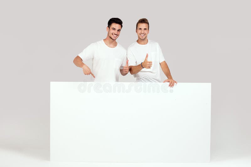 Two Guys Posing with White Empty Board. Stock Photo - Image of adult ...