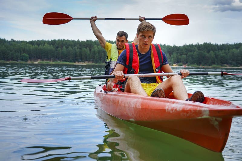 Two Guys in a Red Kayak on the River, in Life Jackets Stock Photo ...