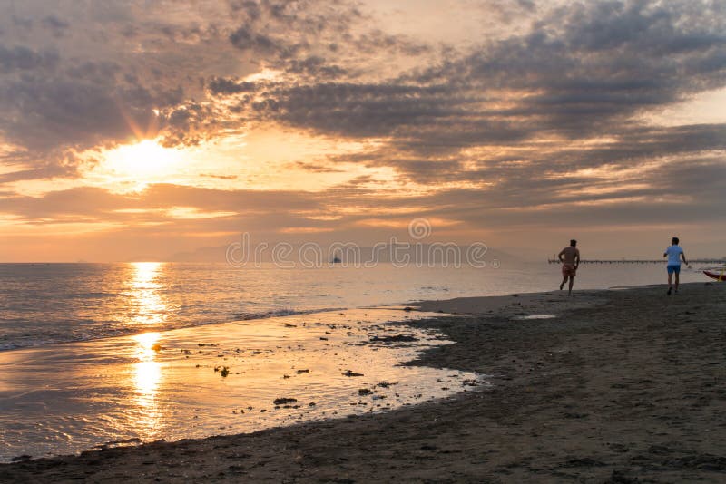Two Guys Running on the Beach at Sunset Editorial Stock Photo - Image ...