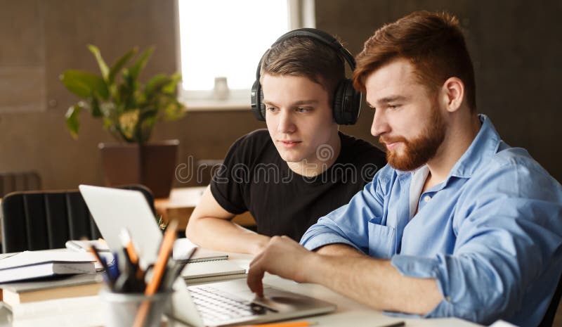 Two Men Working on a Laptop in Library Stock Image - Image of papers ...