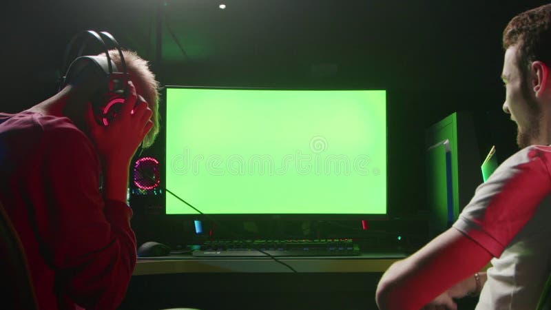 Two Guys are Sitting at a Computer and Looking at a Green Screen Stock ...