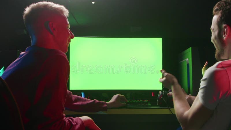 Two Guys are Sitting at a Computer and Looking at a Green Screen Stock ...