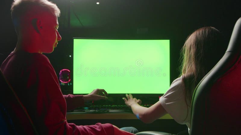 Two Guys are Sitting at a Computer and Looking at a Green Screen Stock ...