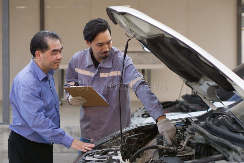 Two Guys are Standing by a Car with the Hood Open, Staring at the ...