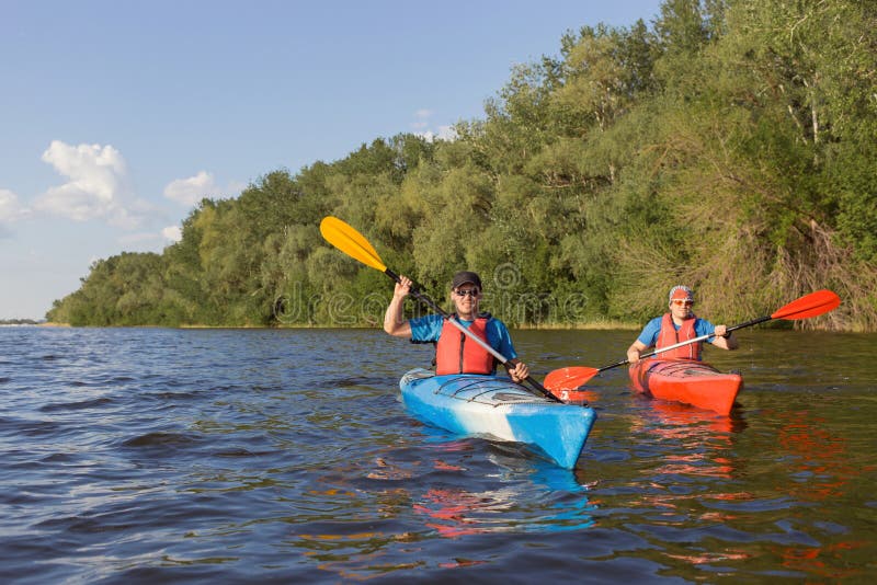 Two Guys Travel the River on a Kayaking . Stock Image - Image of lake ...