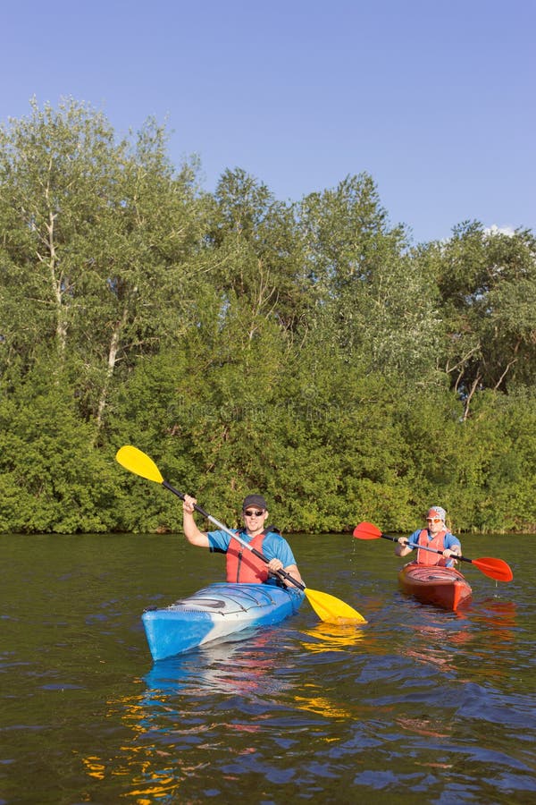 Two Guys Travel the River on a Kayaking . Stock Image - Image of lake ...