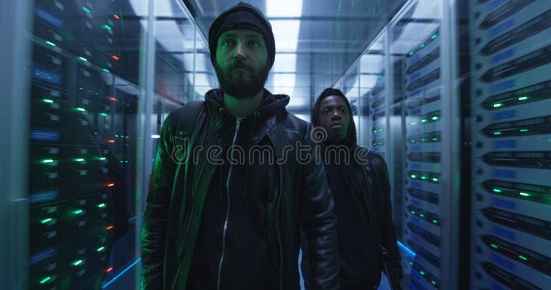 Two Hackers Walking through Rows of Servers Stock Image - Image of ...