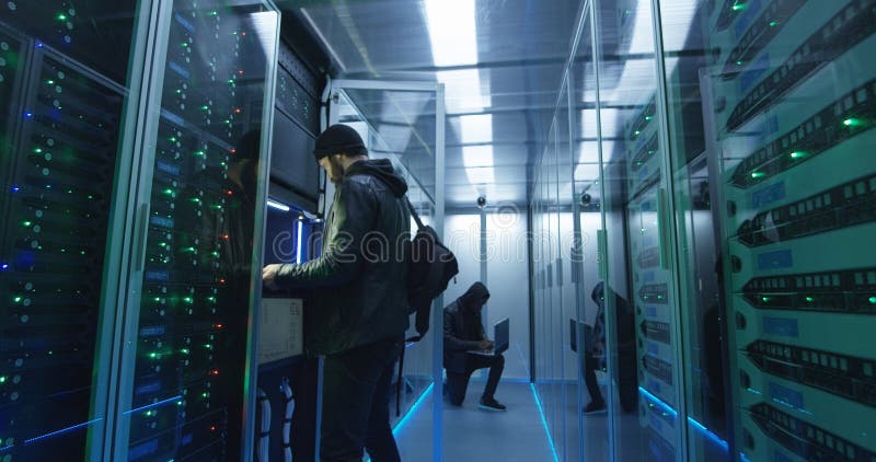 Two Hackers Walking through Rows of Servers Stock Photo - Image of ...