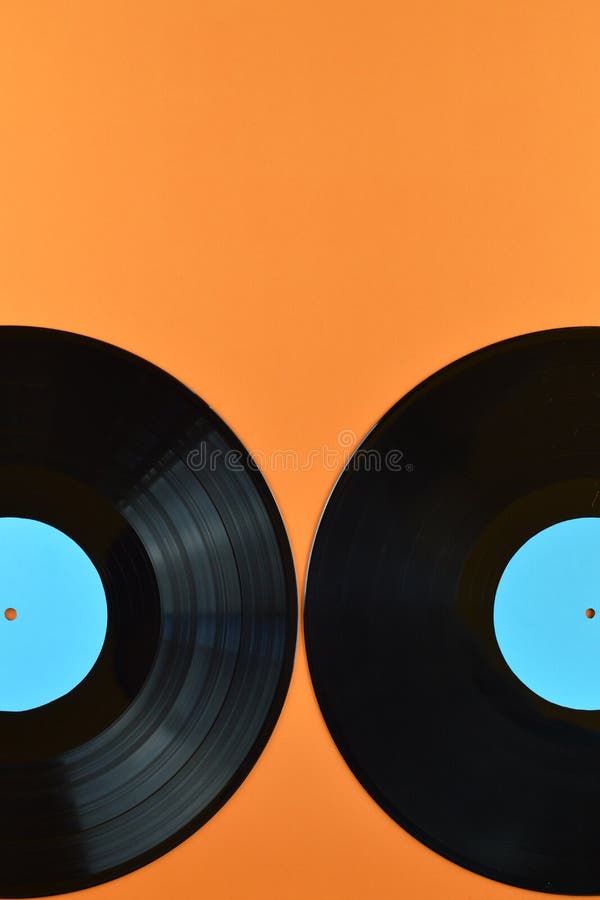 Two Half Black Vinyl Record on Orange Background Stock Photo - Image of ...