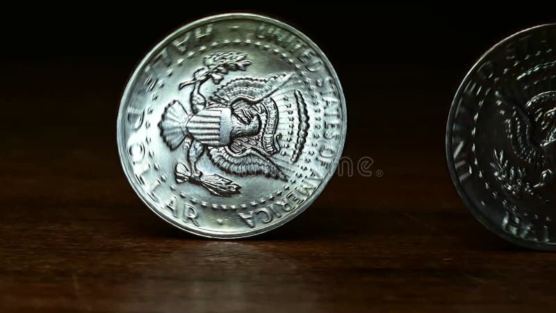 Two Half US Dollar Rolls Across the Table Stock Footage - Video of ...