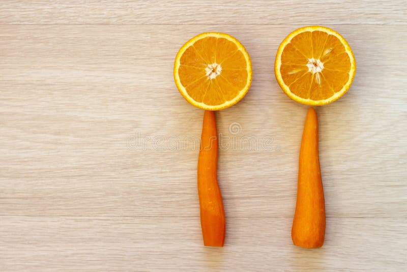 Two Halfs of an Orange and Two Carrots on Wooden Textured Backgr Stock ...