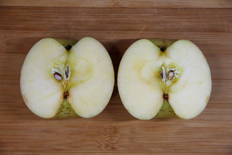 Two Halves of an Apple on a Wooden Background Stock Photo - Image of ...