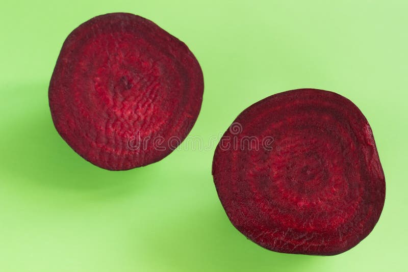 Two Halves of Beets on Green Background. Top View Stock Photo - Image ...