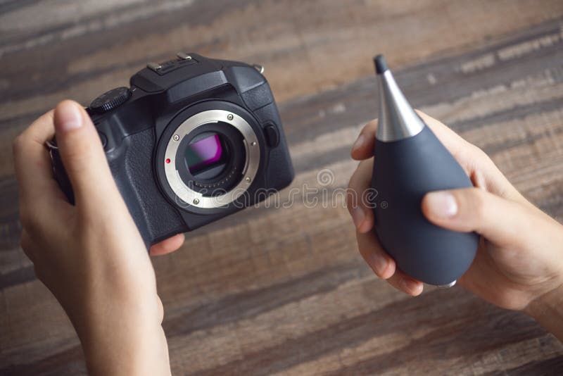 Two Hands Cleaning Digital Camera Sensor from Dust with Air Blower ...