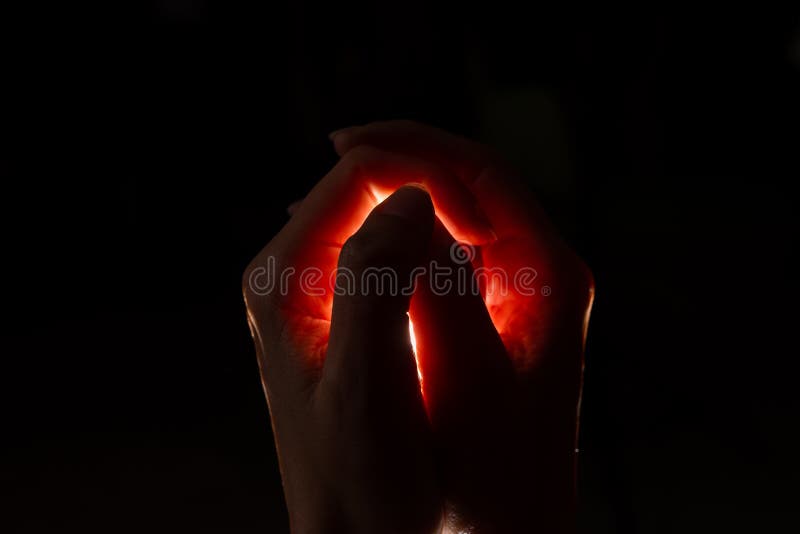 Two Hands Folded Squeeze the Light Inside, Reddish Light Inside the ...