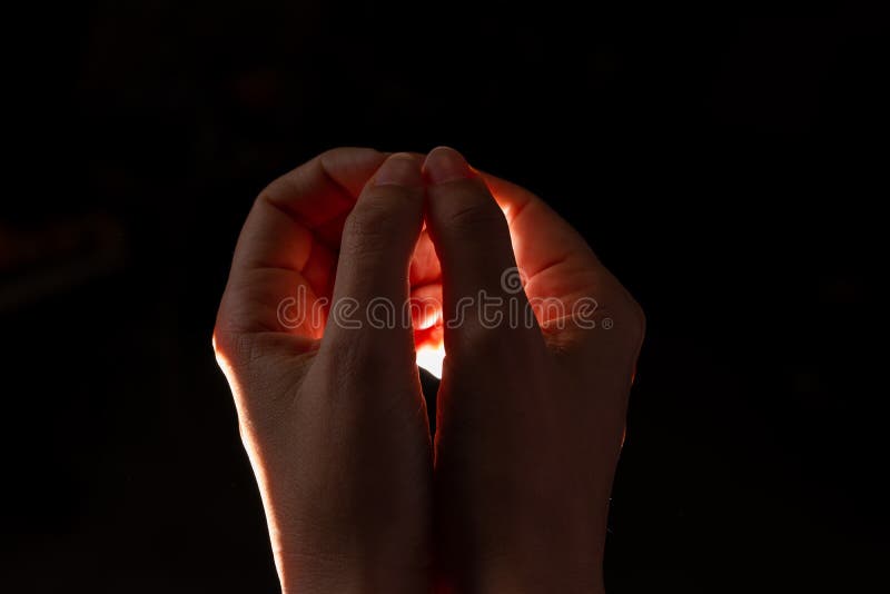 Two Hands Folded Squeeze the Light Inside, Reddish Light Inside the ...