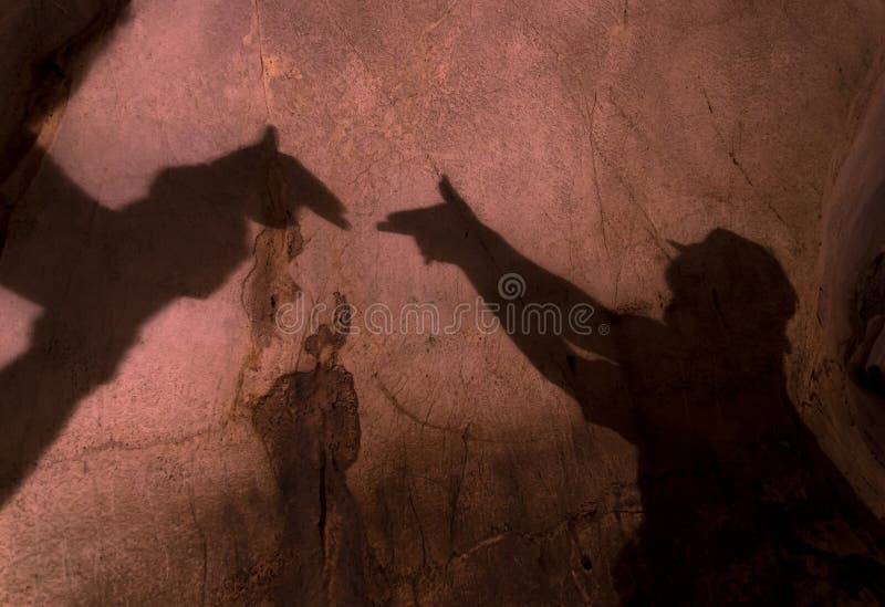 Two Hands Forming a Gun Shadow on the Wall in the Cave Stock Image ...