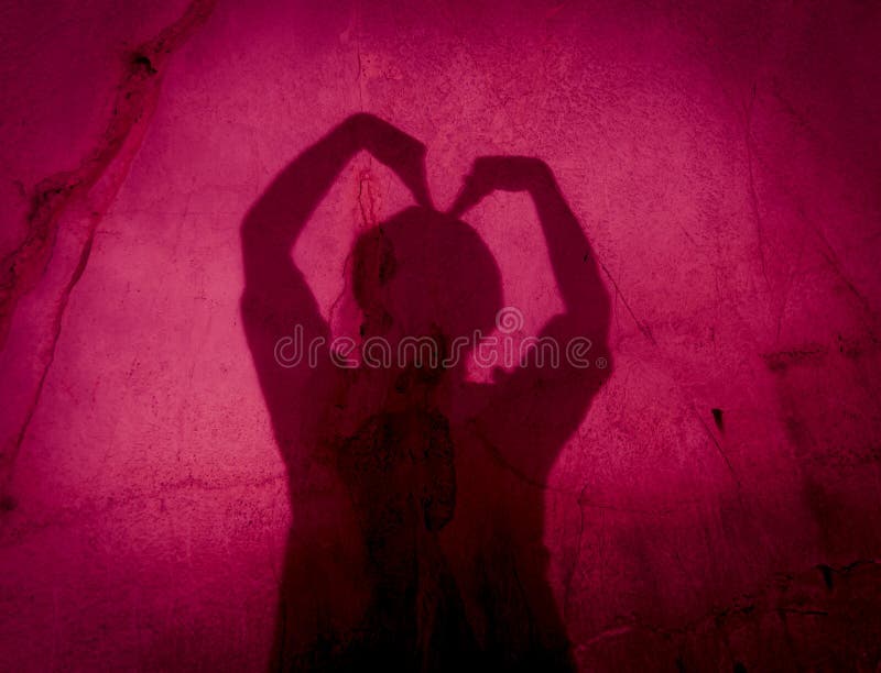 Two Hands Forming a Heart Shadow on the Wall in the Cave Stock Image ...