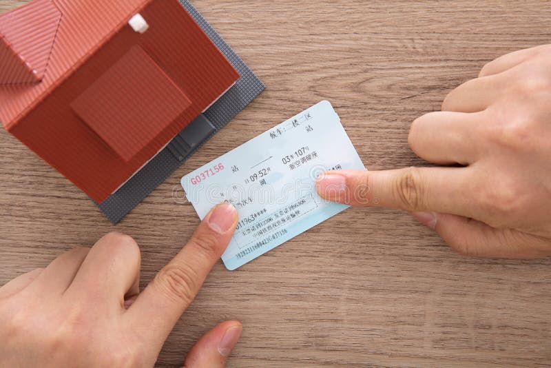Two Hands are Grabbing a Train Ticket in Front of the House Model Stock ...