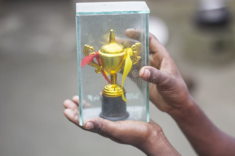 Two Hands Hold a Madel and the Background is Blurred Stock Photo ...