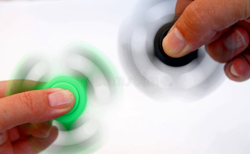 Two Hands Holding Fidget Spinners Stock Image - Image of anxiety ...