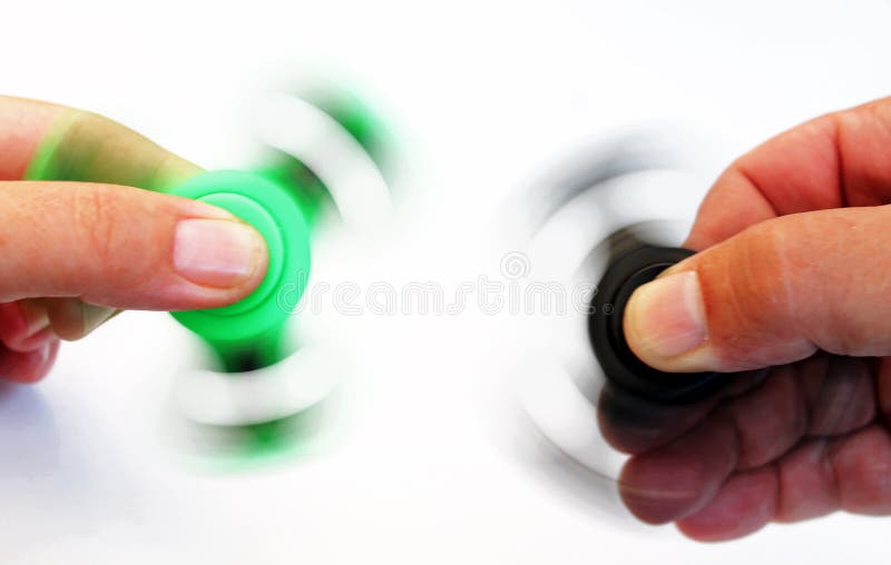Two Hands Holding Spinning Fidget Spinners Stock Image - Image of ...