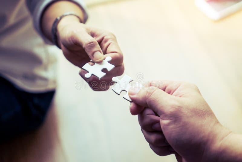 Two Hands Joining Together Two Jigsaw Stock Photo - Image of pieces ...