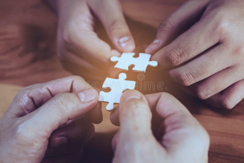 Hands Joining Two Puzzle Pieces. Stock Photo - Image of conceptual ...
